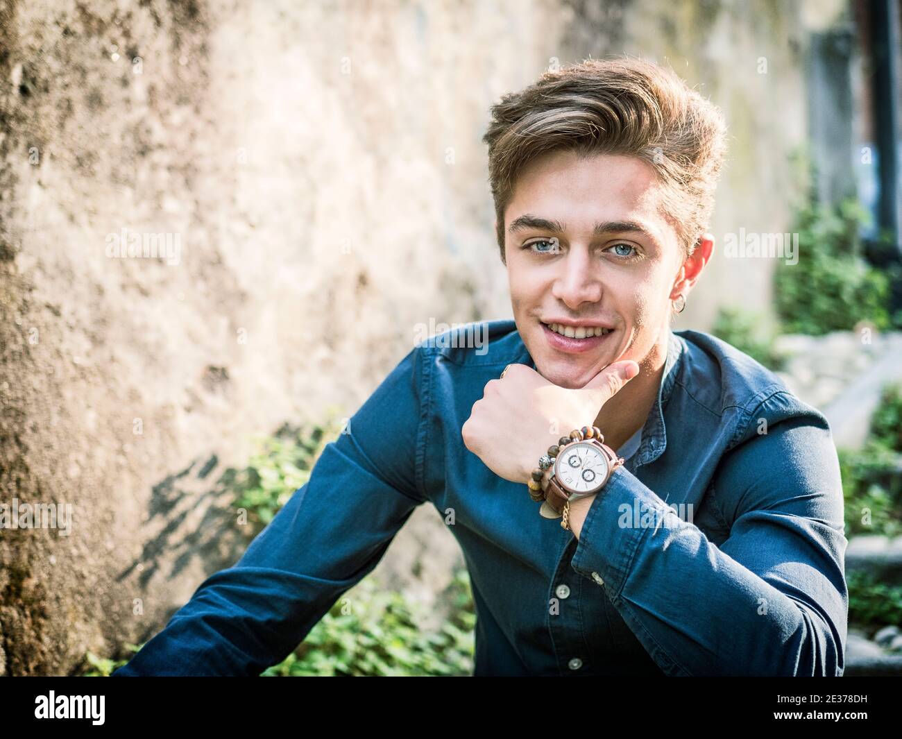 One handsome young man in city setting smiling Stock Photo - Alamy