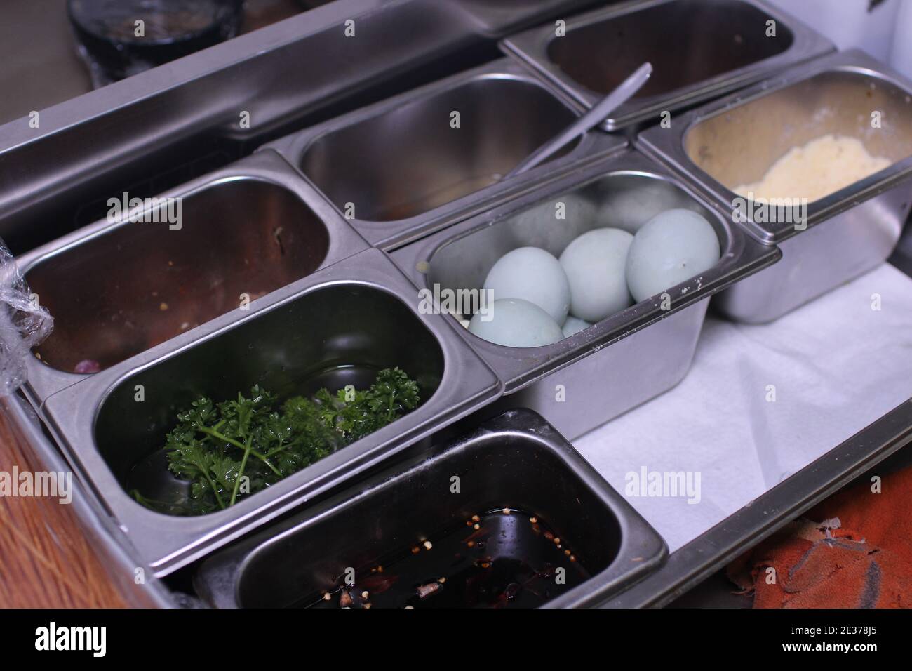 Kitchen preparation ingredient. Boiled egg, garnish, chilli ketchup and ...