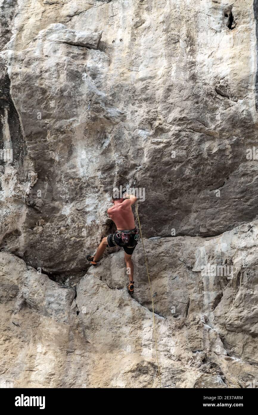 Mountain climber climbing at top alpine rock education and training ...