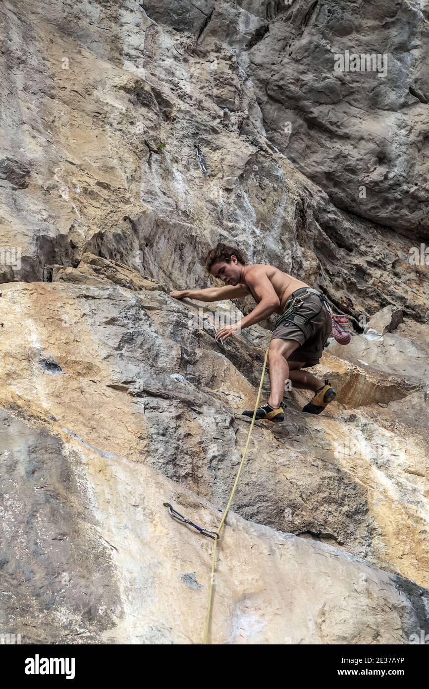 Sportive male alpinist training climbing on cliff rock with rope Stock ...