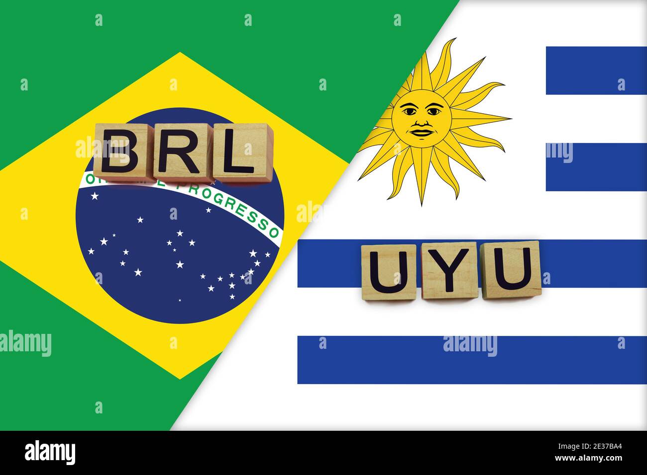 Brazil and Uruguay currencies codes on national flags background ...