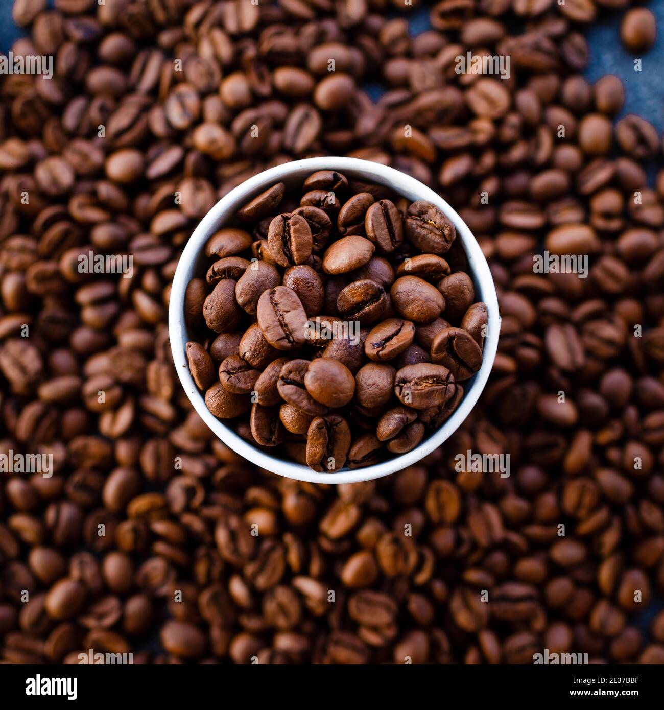 Coffee beans in a paper cup Stock Photo - Alamy