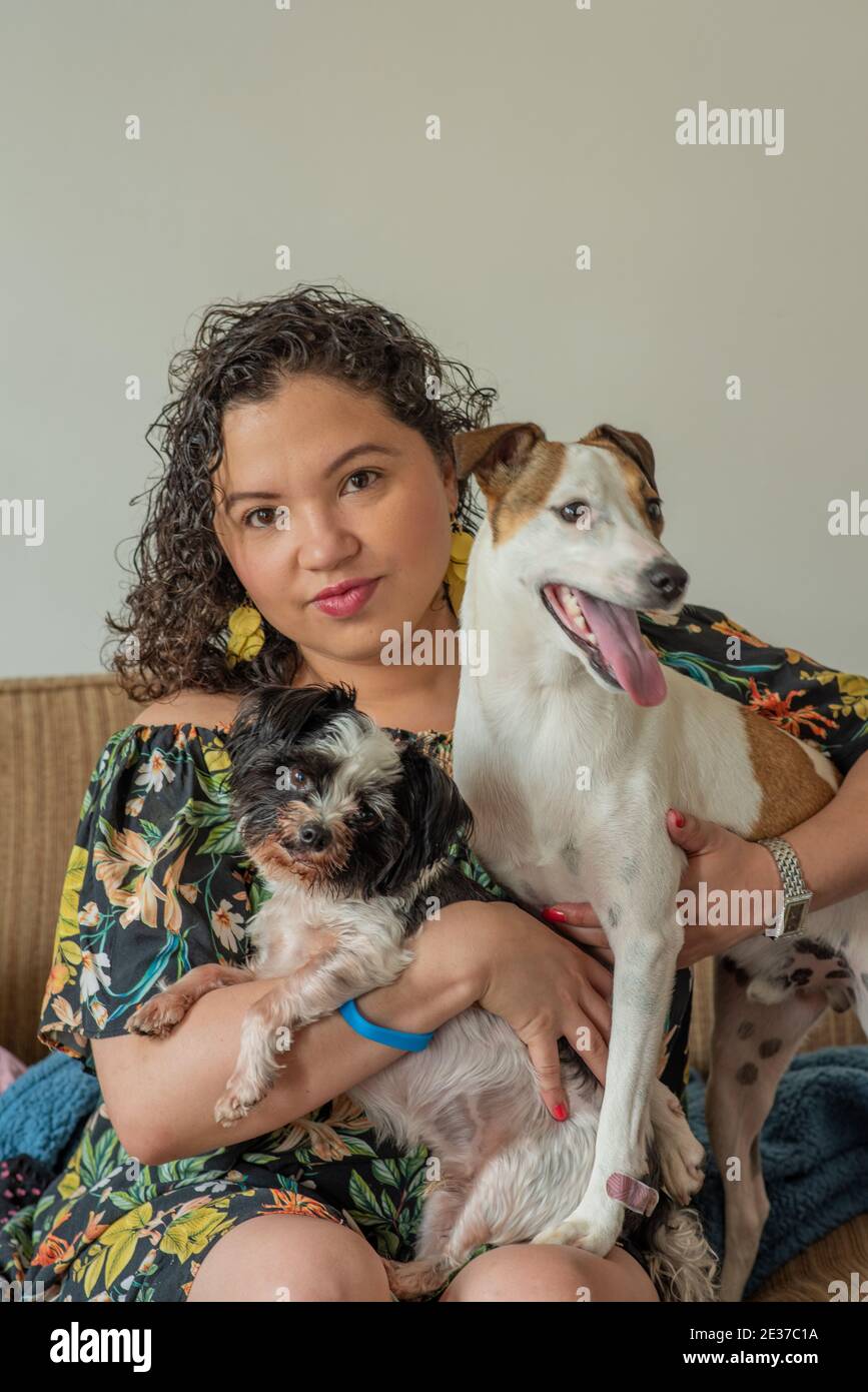 Woman holding two dogs hi-res stock photography and images - Alamy