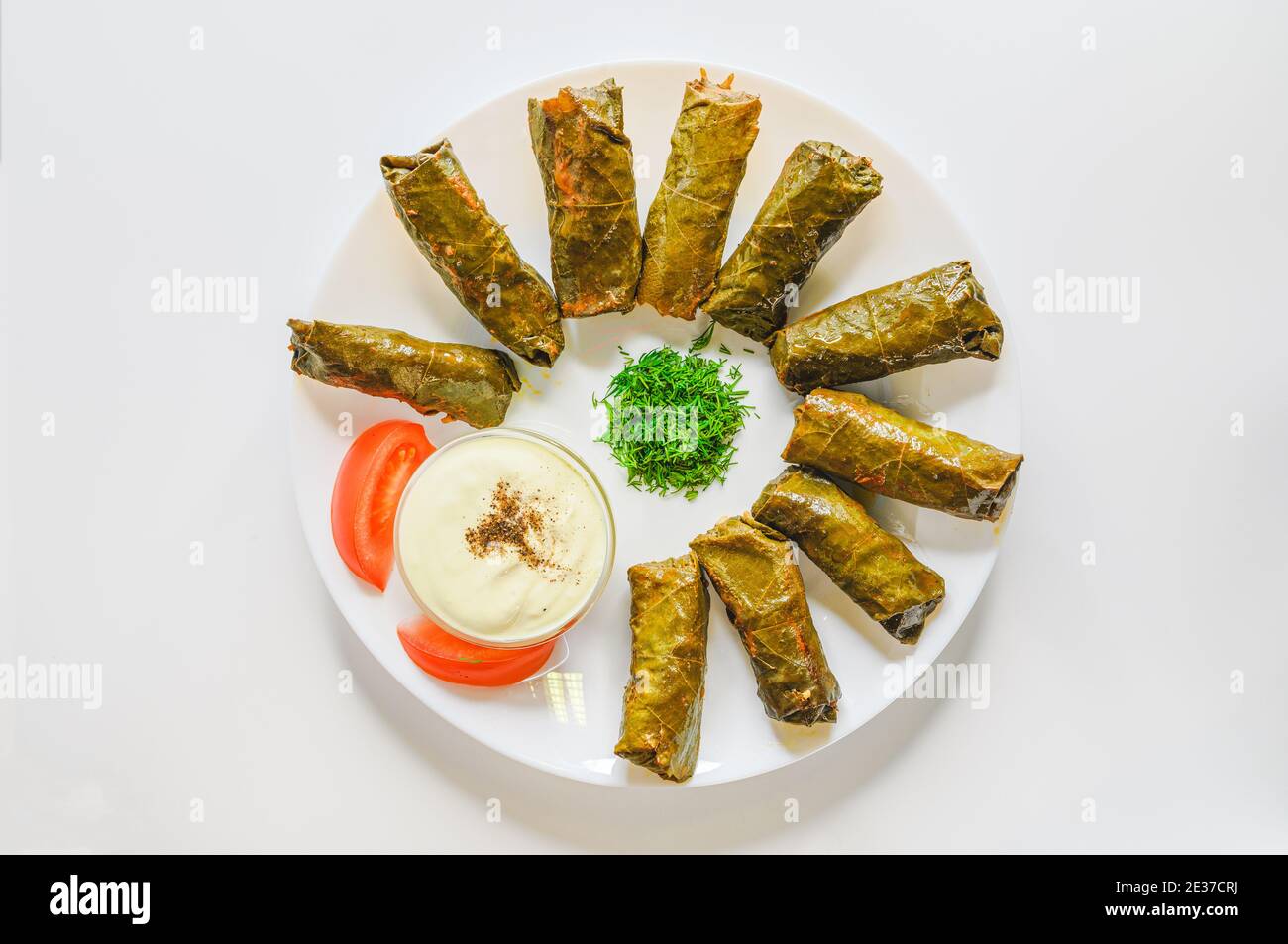 Top view of Lamb wrapped in grape leaves. Dolma with sauce and ...