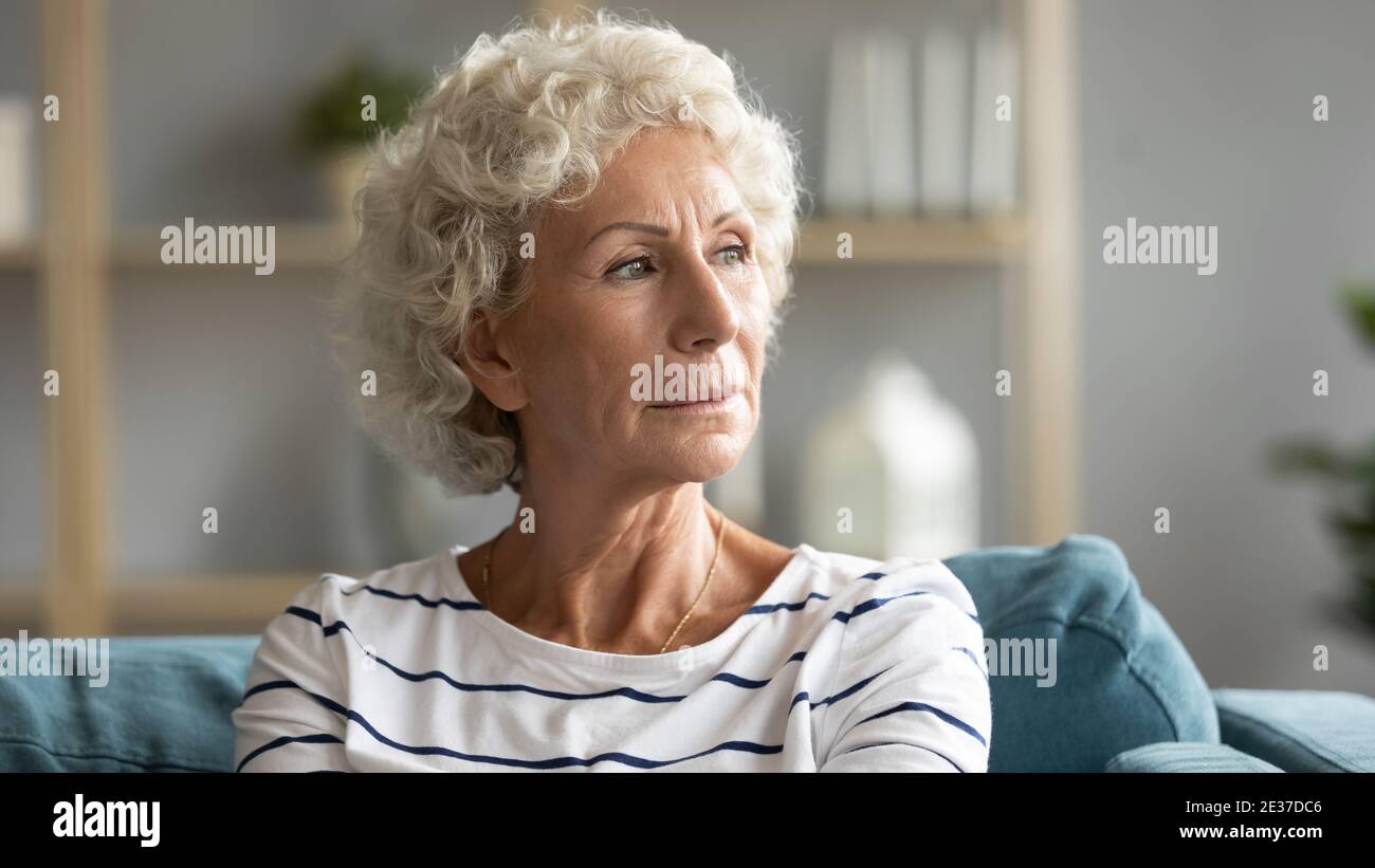 Pensive old senior hoary woman looking in distance Stock Photo - Alamy