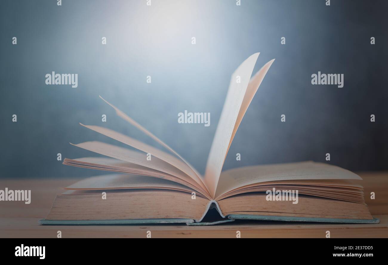 book opening on table education and learning concept Stock Photo - Alamy