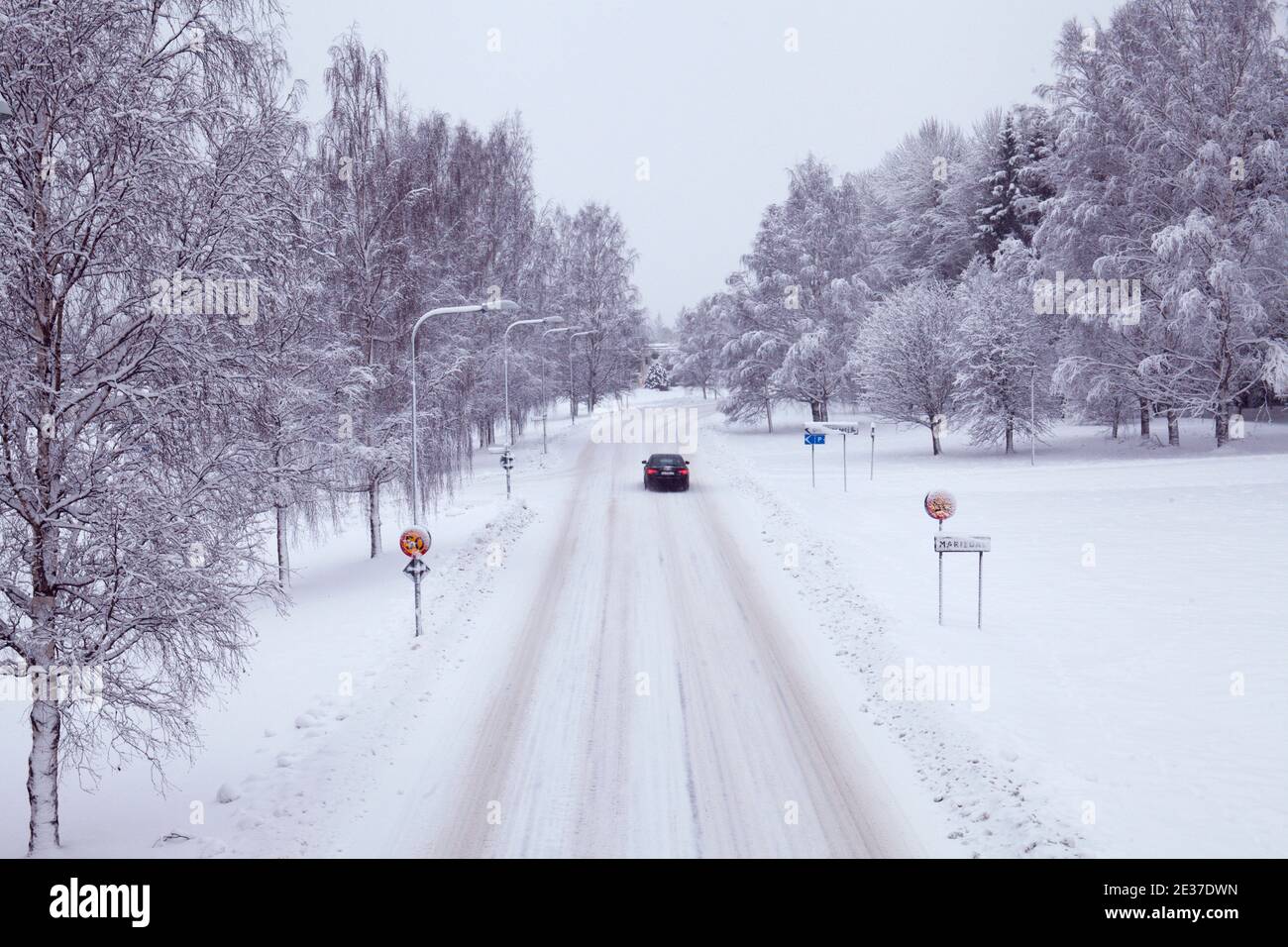 View of a modern street, road after a snowy night. Signs, snow and ...
