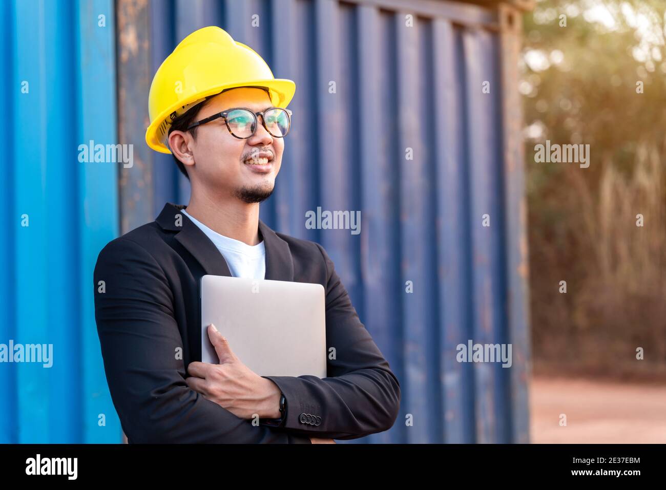 asian yong business man import and export goods wear a helmet logitics ...