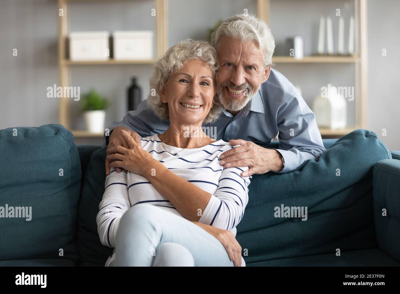 Affectionate caring middle aged man cuddling smiling wife Stock Photo ...
