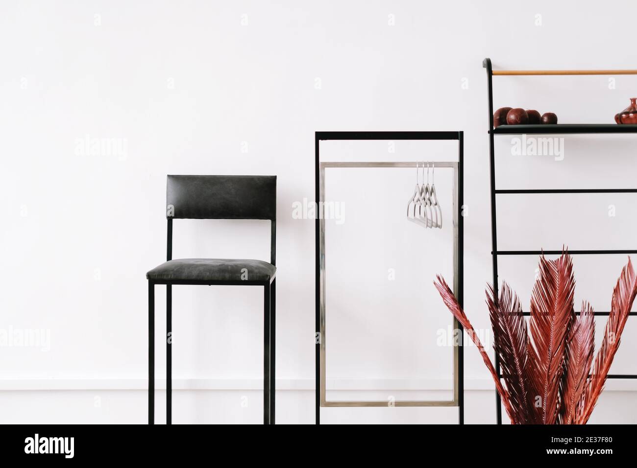 Minimal interior design of living room with clothing floor rack, chair ...