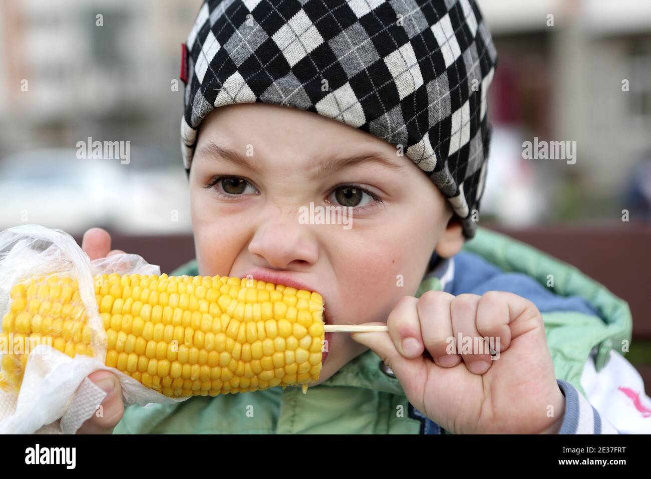Child eating corn in the park in spring Stock Photo - Alamy