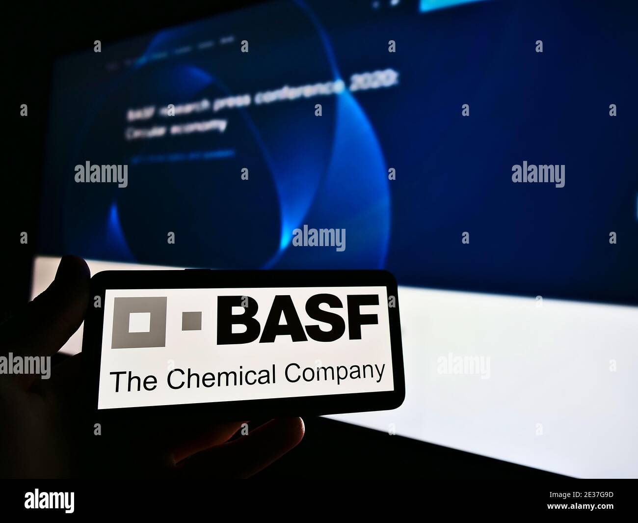 Person holding smartphone with logo of German multinational company ...