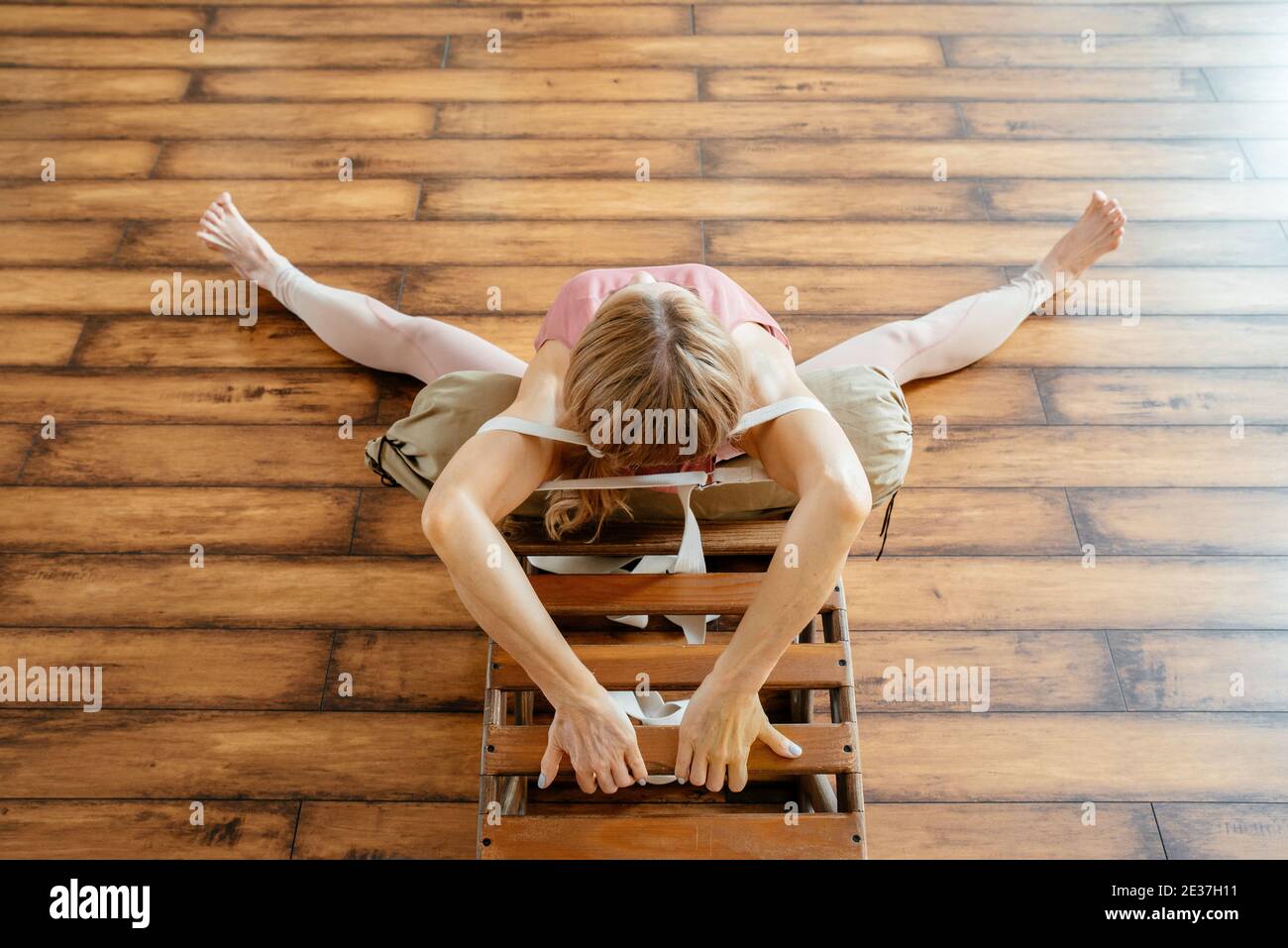 Mature woman doing Stretching Exercises On Yoga Backbend Bench in ...
