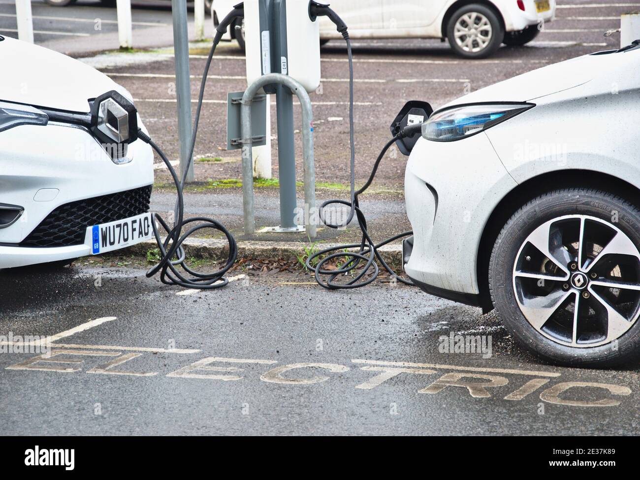 Electric hire cars in designated spaces at roadside charging points ...