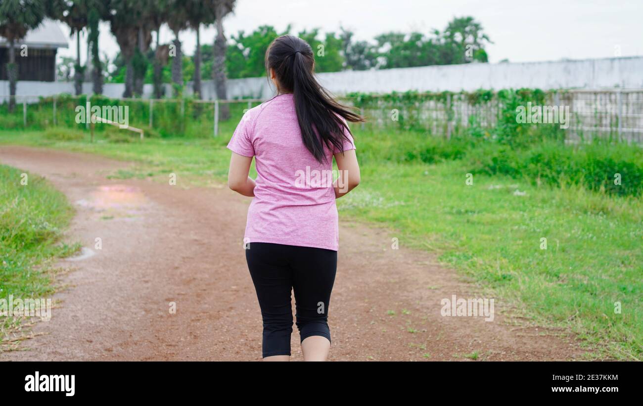 asian woman athlete running on track. back view Stock Photo - Alamy