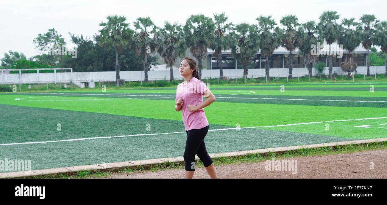 asian woman athlete running on track Stock Photo - Alamy