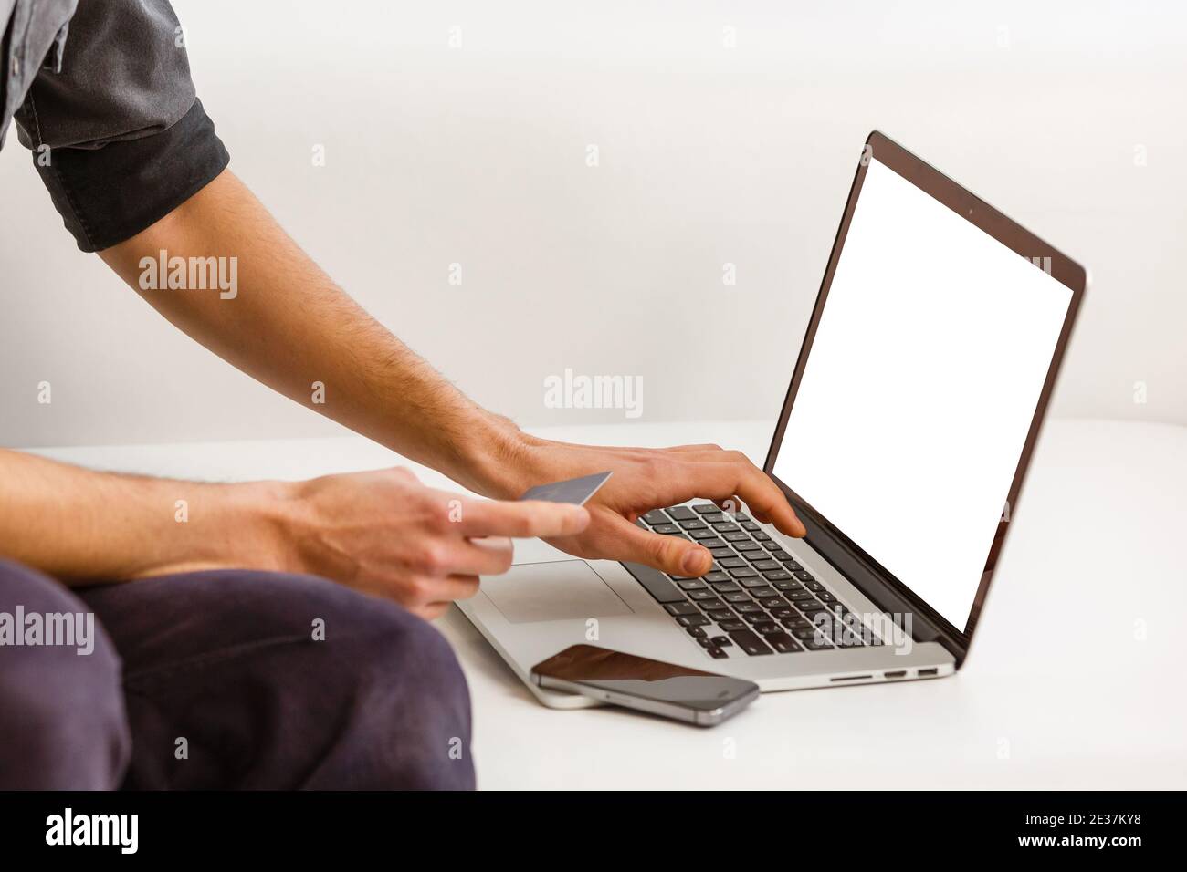 Back view of male person sitting front open laptop computer with blank ...