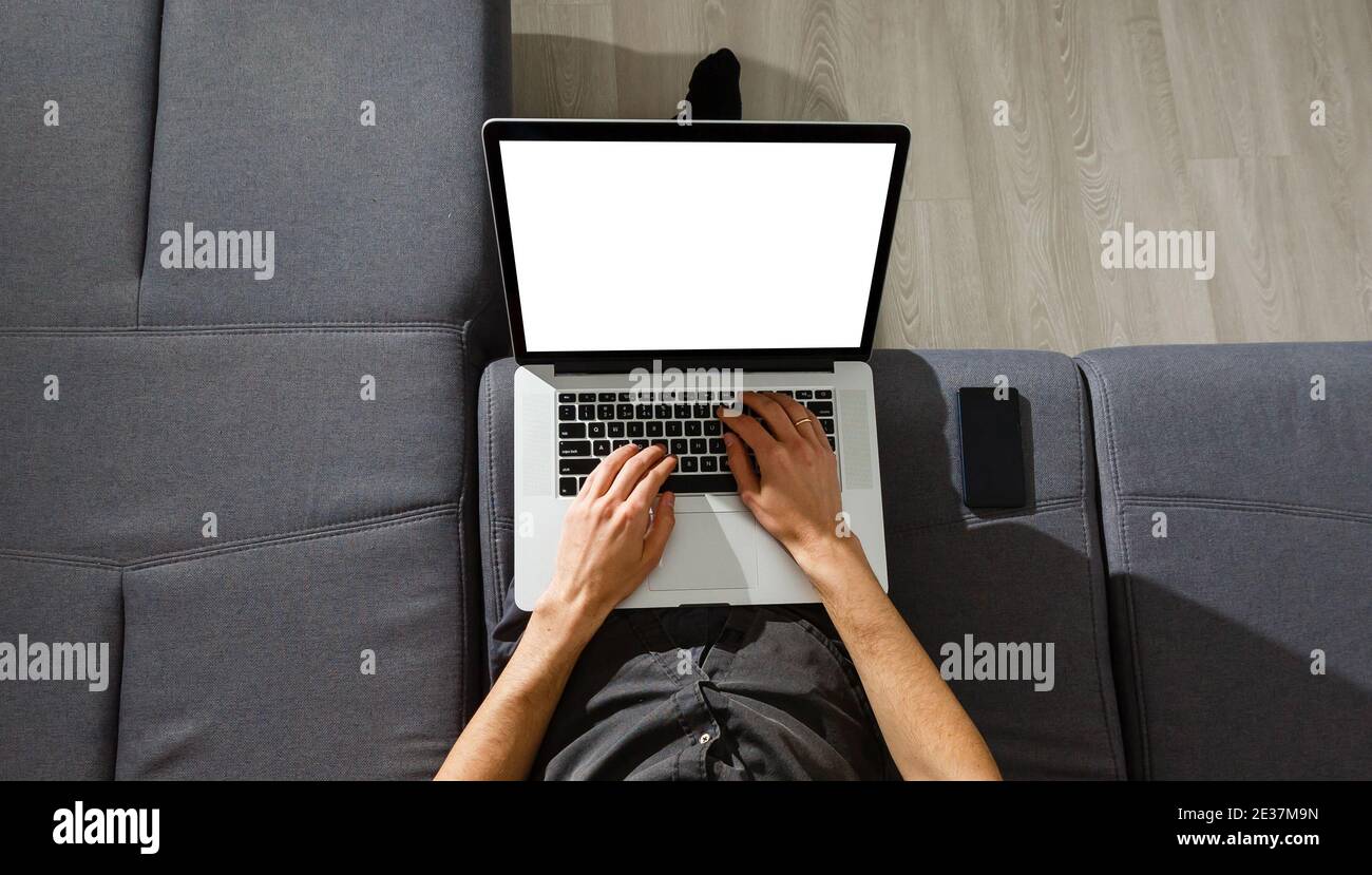 Back view of male person sitting front open laptop computer with blank ...