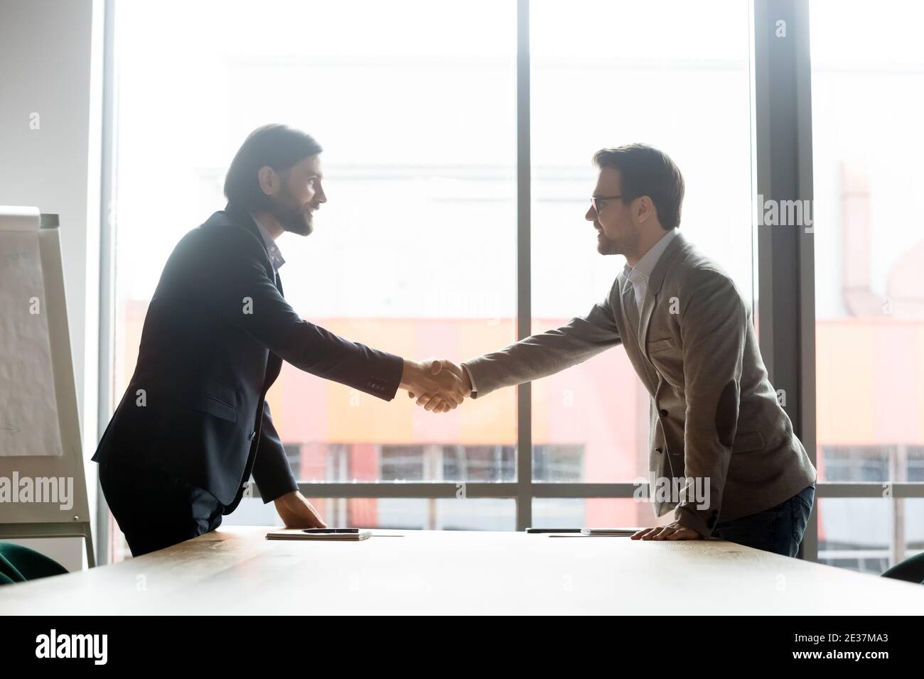 Happy male business partners hi-res stock photography and images - Alamy