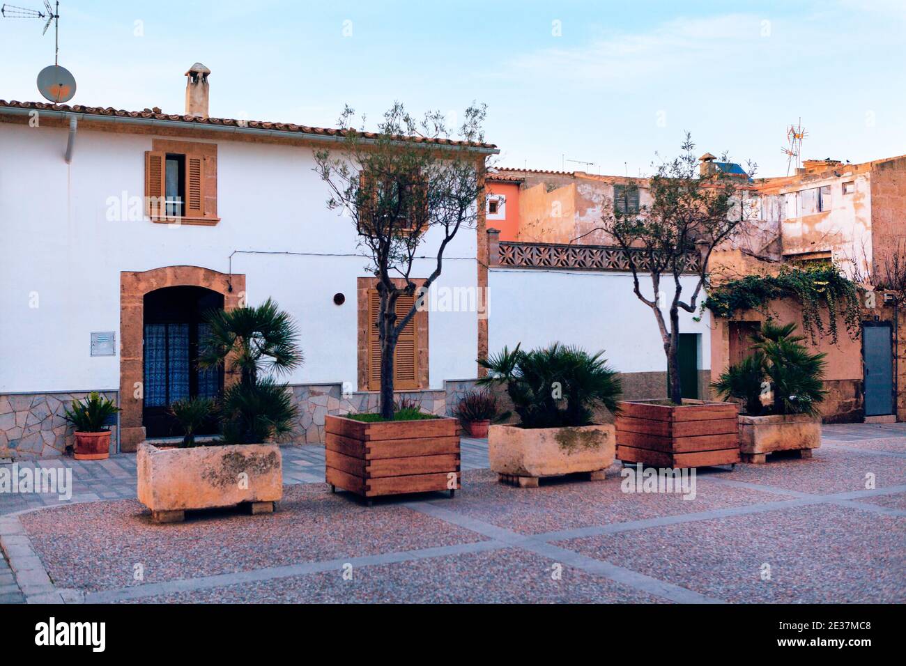 Spanish district with old houses . Street flowerbeds on the pavement ...