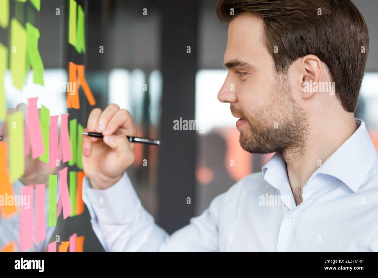 Smiling young male manager developing corporate growth strategy Stock ...