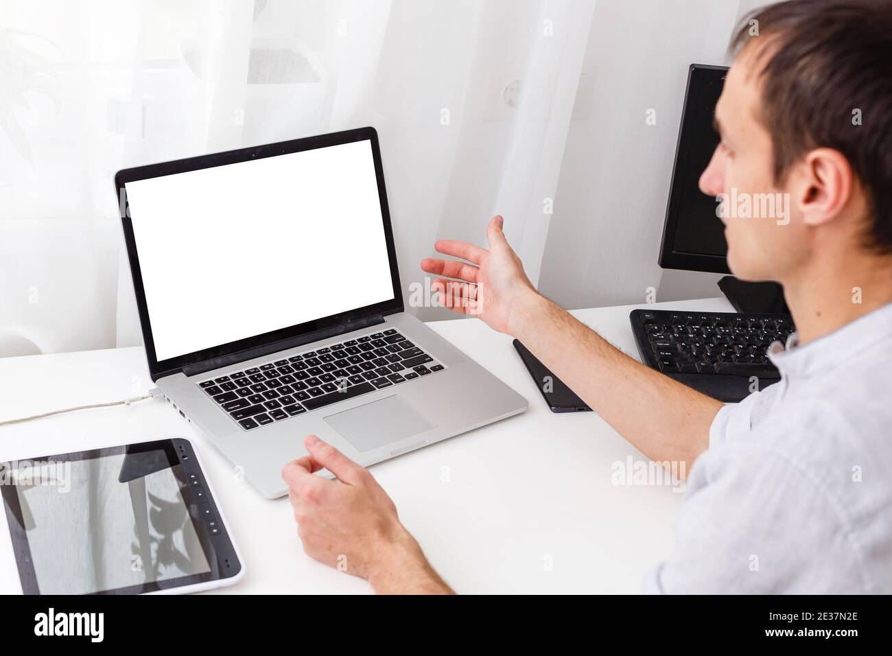 Back view of male person sitting front open laptop computer with blank ...