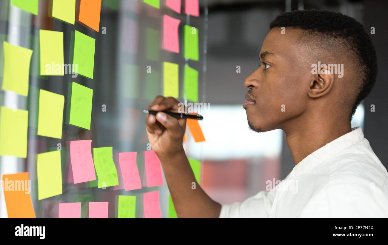 Concentrated african american male employee managing working tasks ...