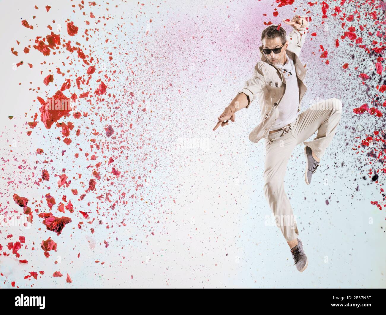 Handsome, flexible dancer jumping into the paint splash Stock Photo - Alamy