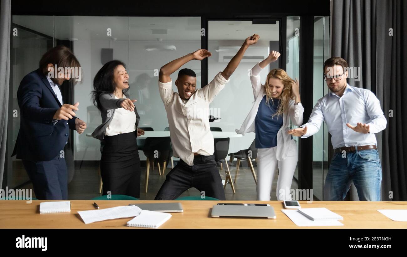 Crazy emotional multiracial business people having fun in office Stock ...