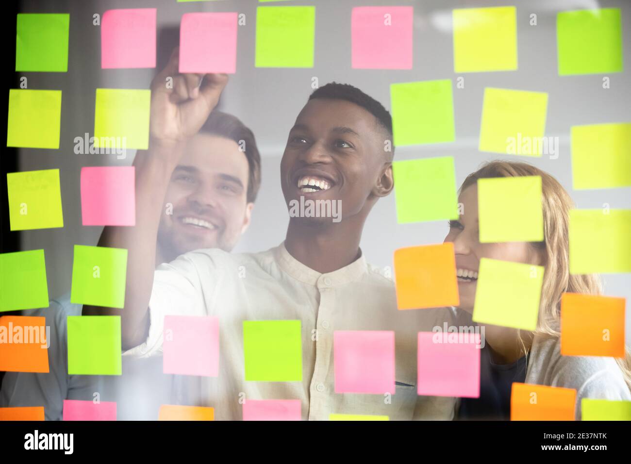 Happy young african american male employee organizing working processes ...