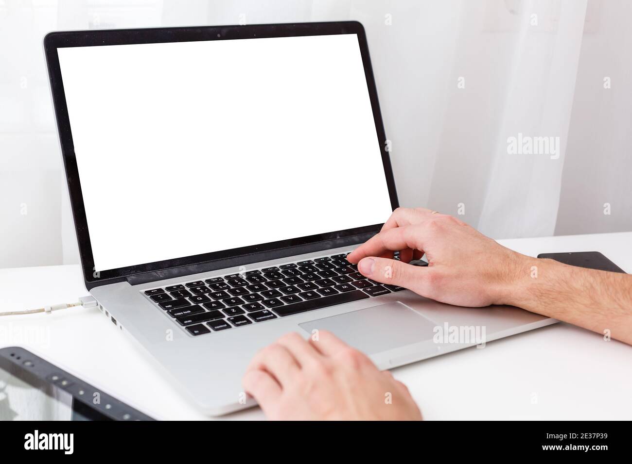 Back view of male person sitting front open laptop computer with blank ...