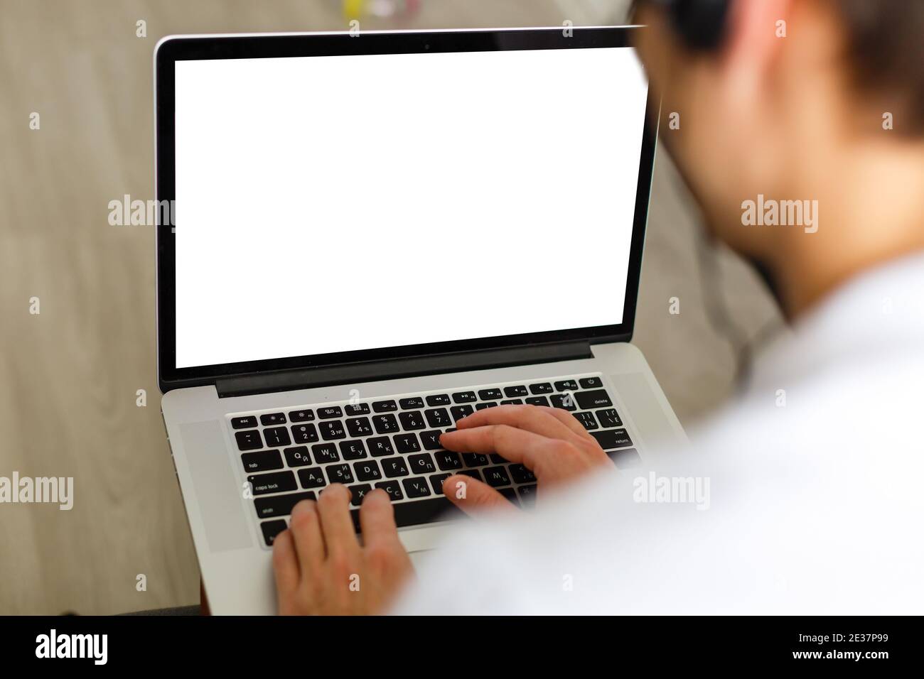 Back view of male person sitting front open laptop computer with blank ...