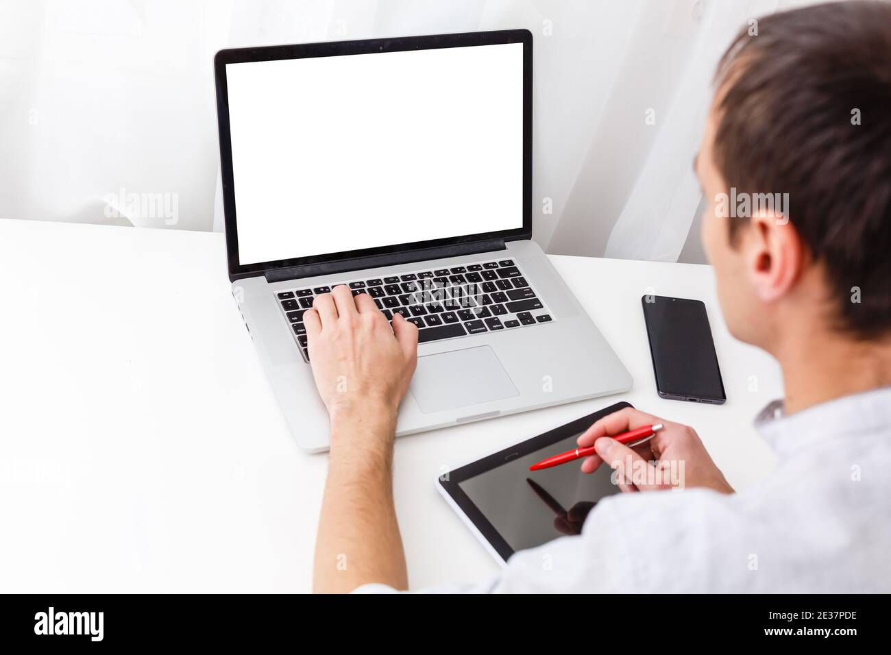Back view of male person sitting front open laptop computer with blank ...