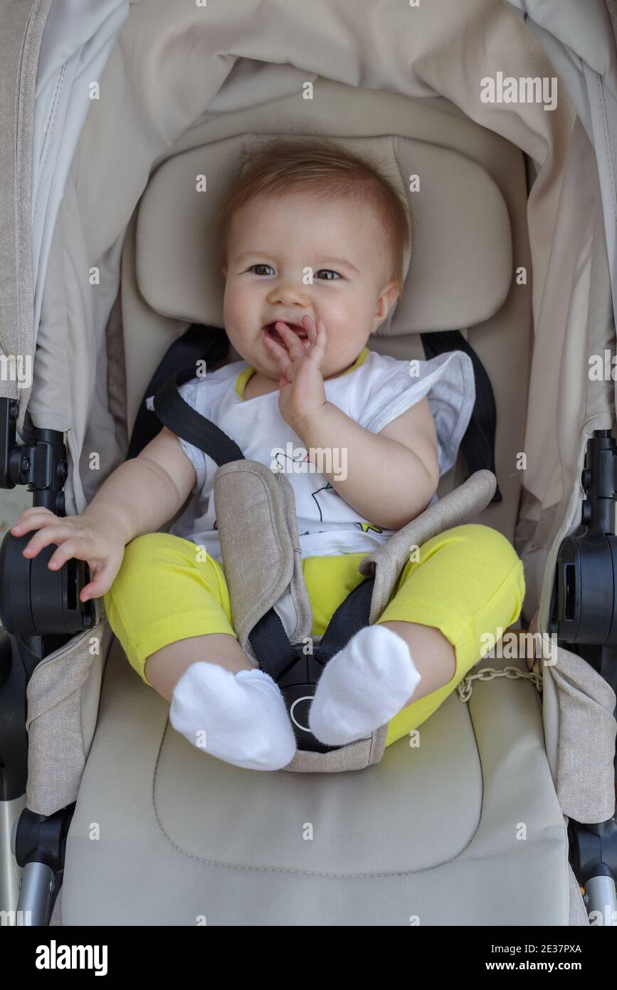 Close-up of cute baby girl in baby stroller outdoor Stock Photo - Alamy