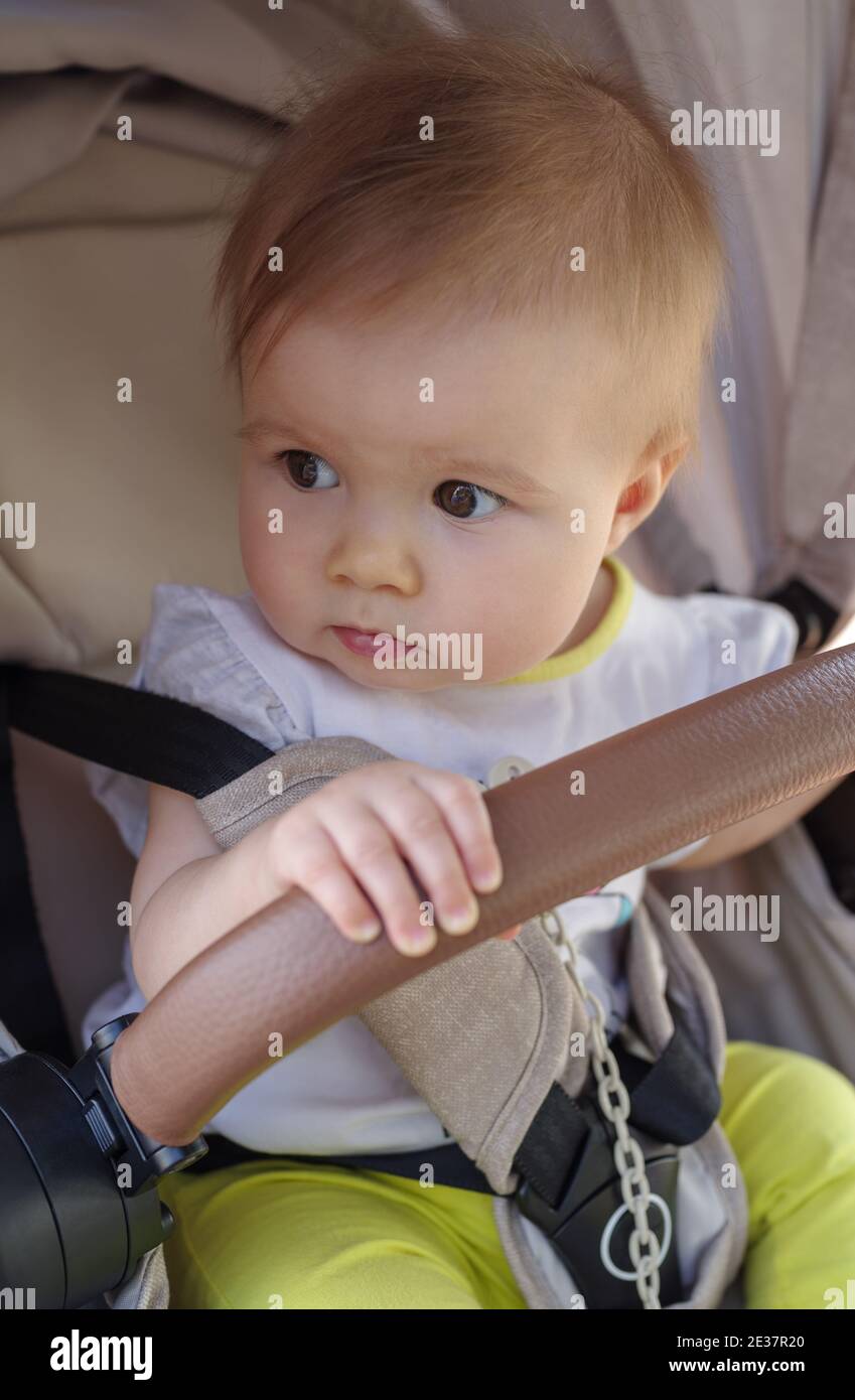 Close-up of cute baby girl in baby stroller outdoor Stock Photo - Alamy