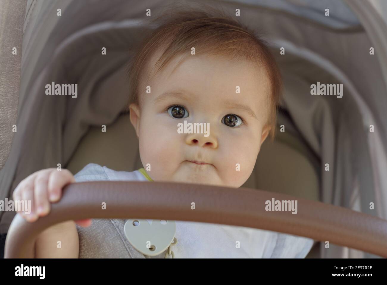 Close-up of cute baby girl in baby stroller outdoor Stock Photo - Alamy