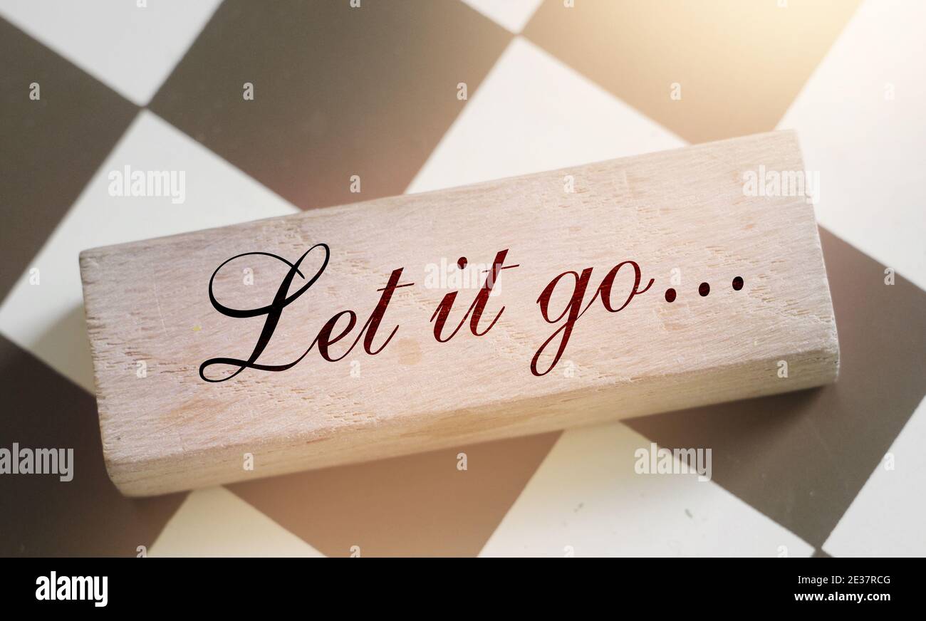 Let It Go wooden sign with a chess on background. Phylosophy ...