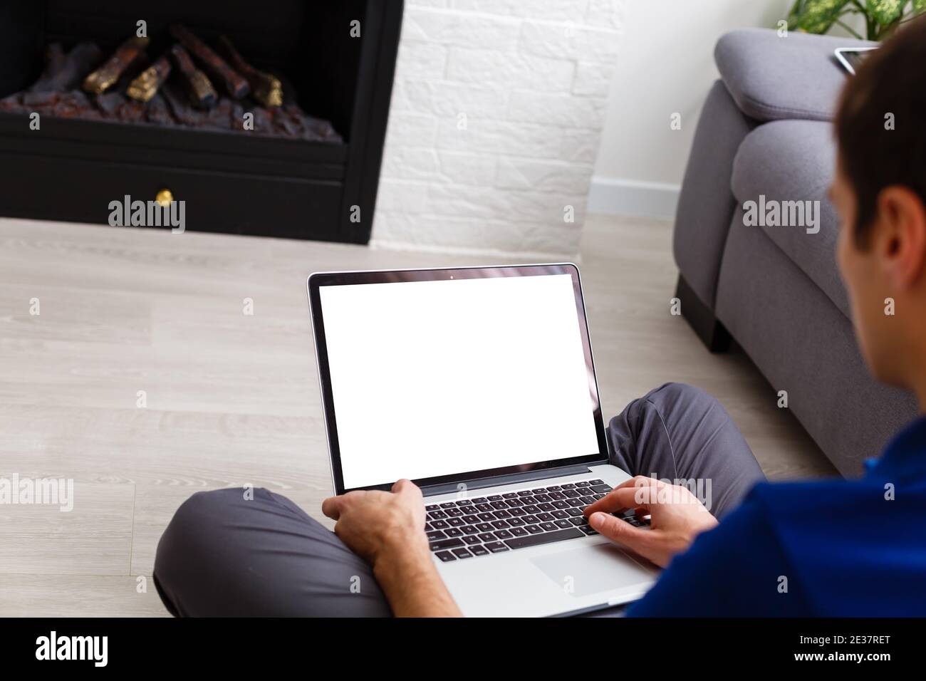 Back view of male person sitting front open laptop computer with blank ...