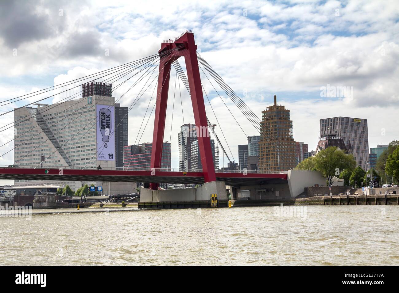 Red metal bridge, with suspension cables in Rotterdam, Holland ...