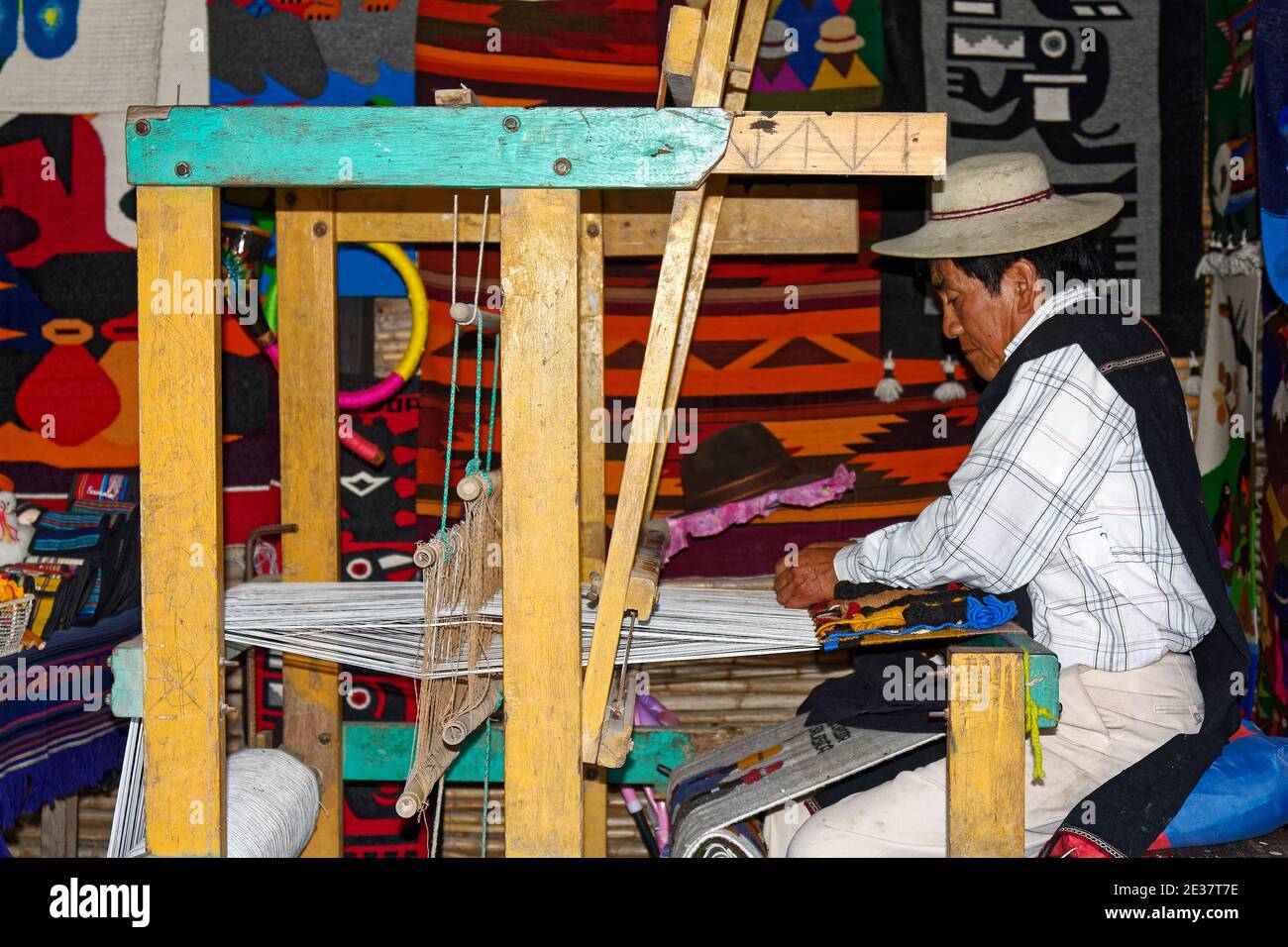 Indigenous man, weaving; large wood loom; native designs; occupation ...