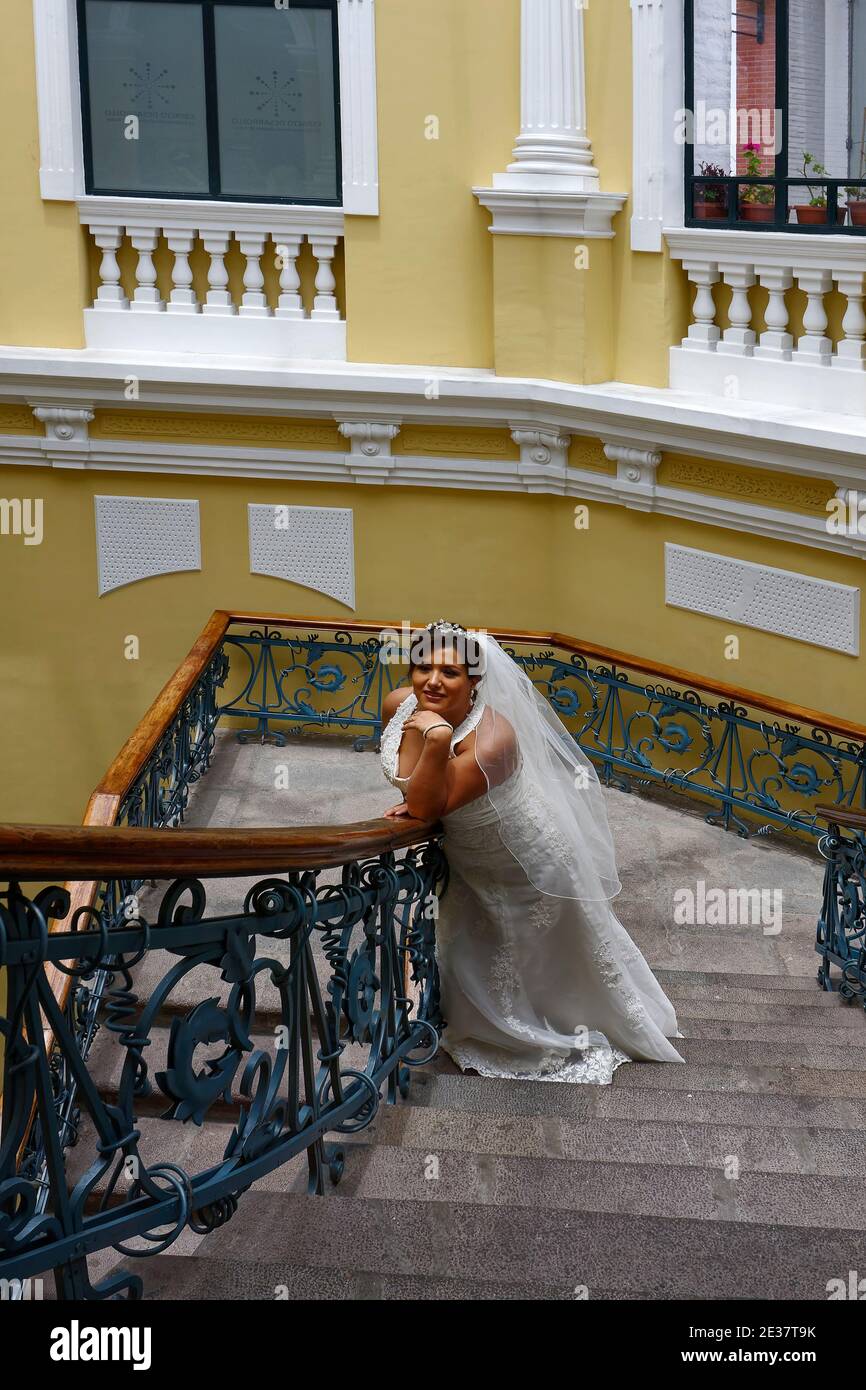 bride posing, stone staircase, view from above, decorative railing ...