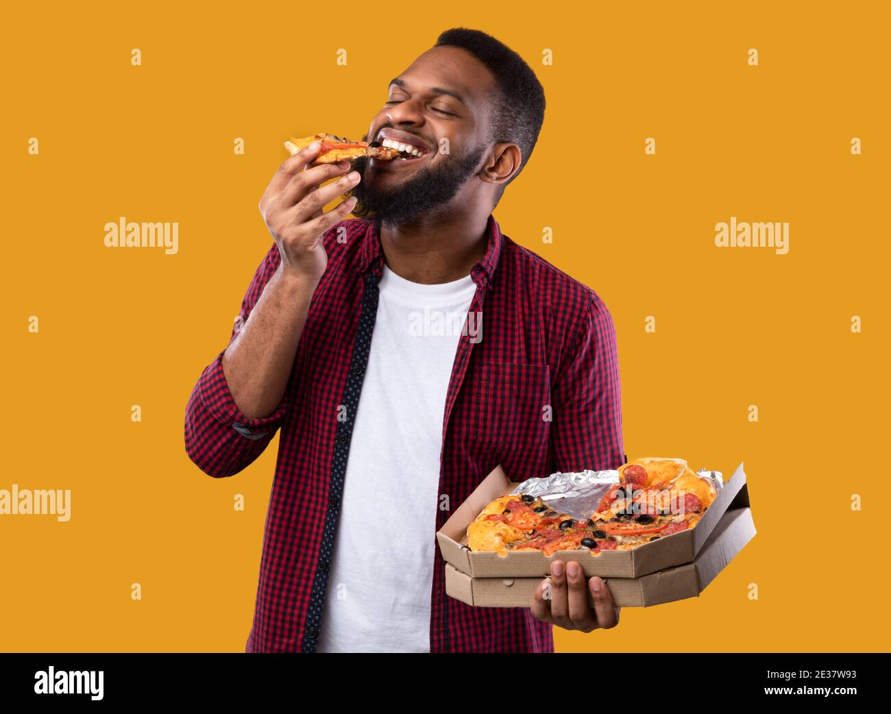 African Young Man Enjoying Pizza Posing With Box, Yellow Background ...