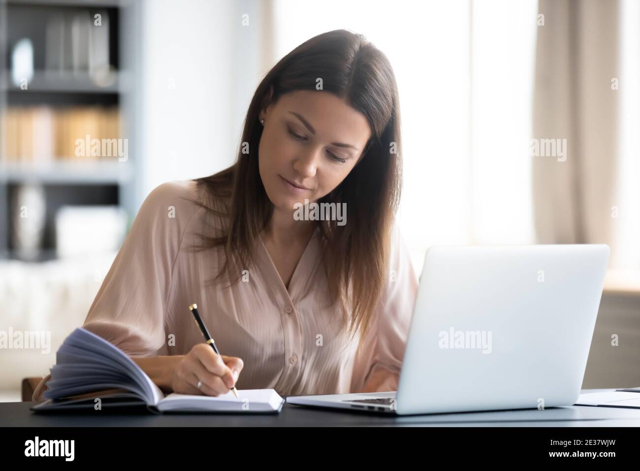 Close up woman writing at desk hi-res stock photography and images - Alamy