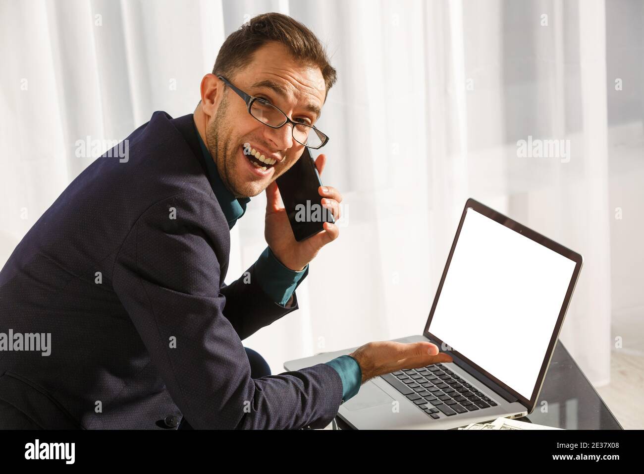 Back view of male person sitting front open laptop computer with blank ...