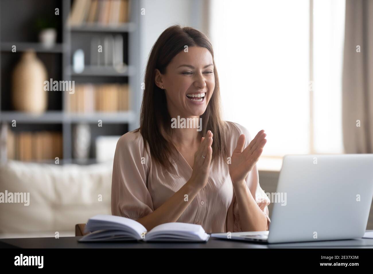 Overjoyed woman looking at laptop screen, surprised by good news Stock ...