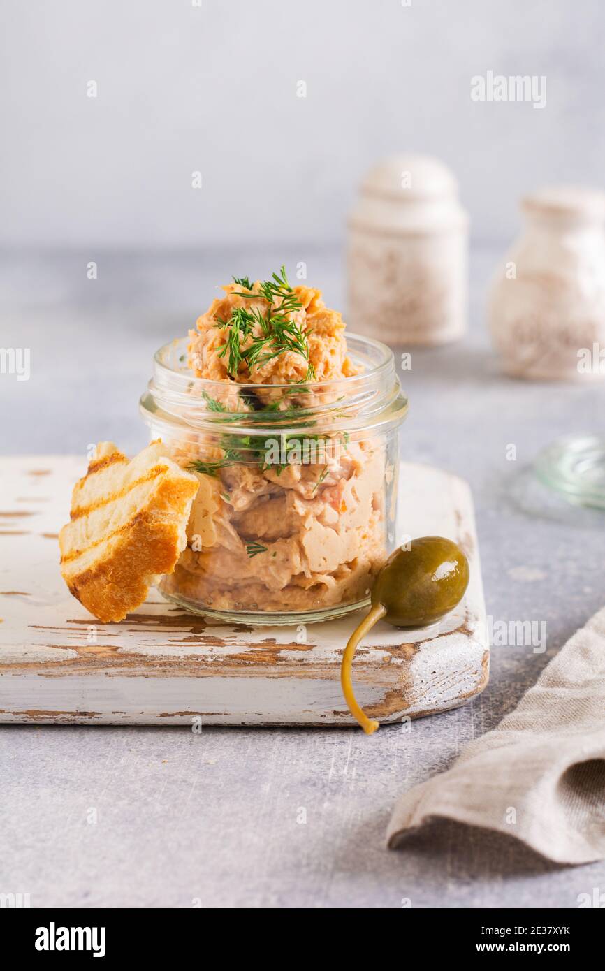 Delicious homemade chicken pate with spices and dill in a glass jar and ...