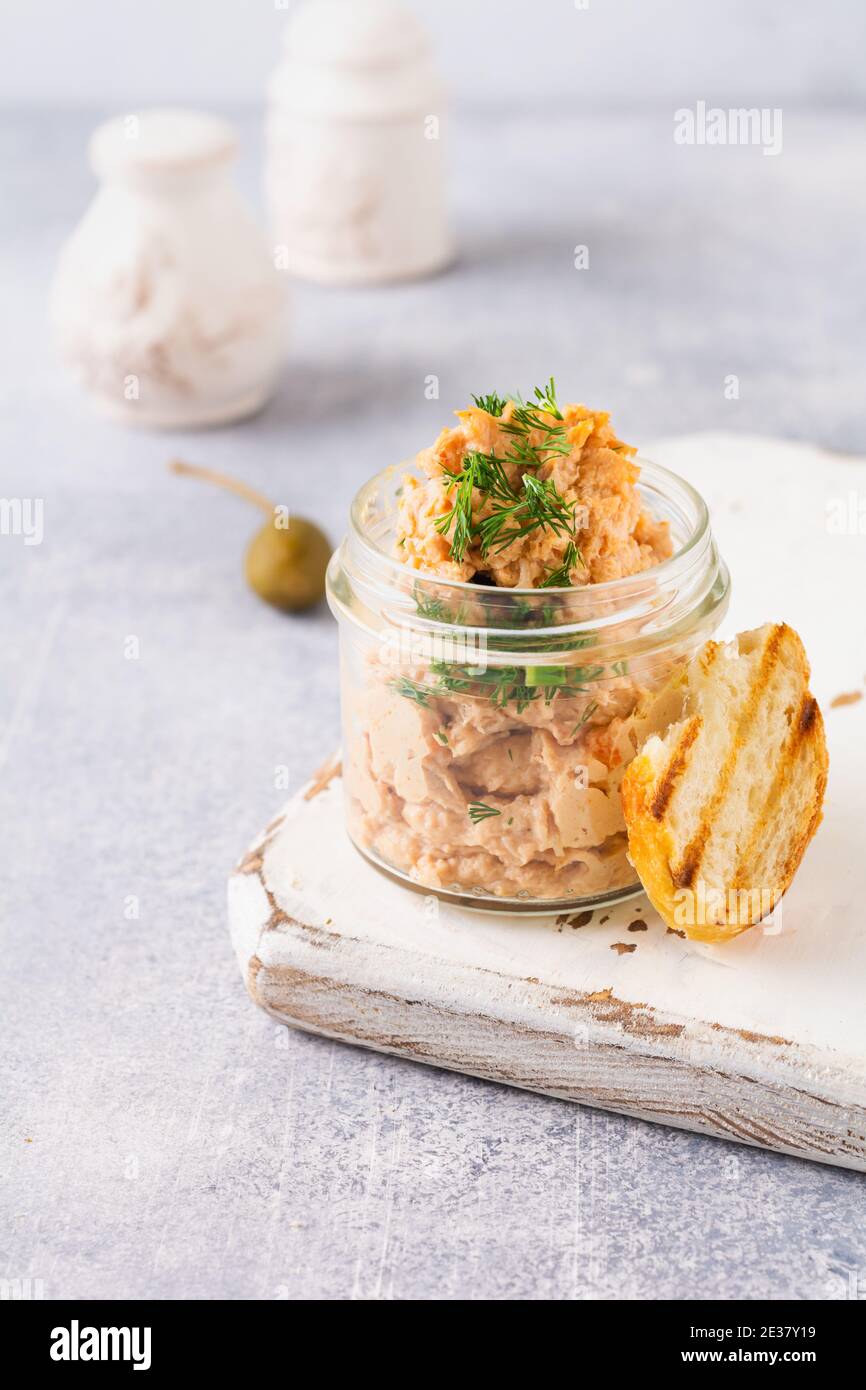 Delicious homemade chicken pate with spices and dill in a glass jar and ...