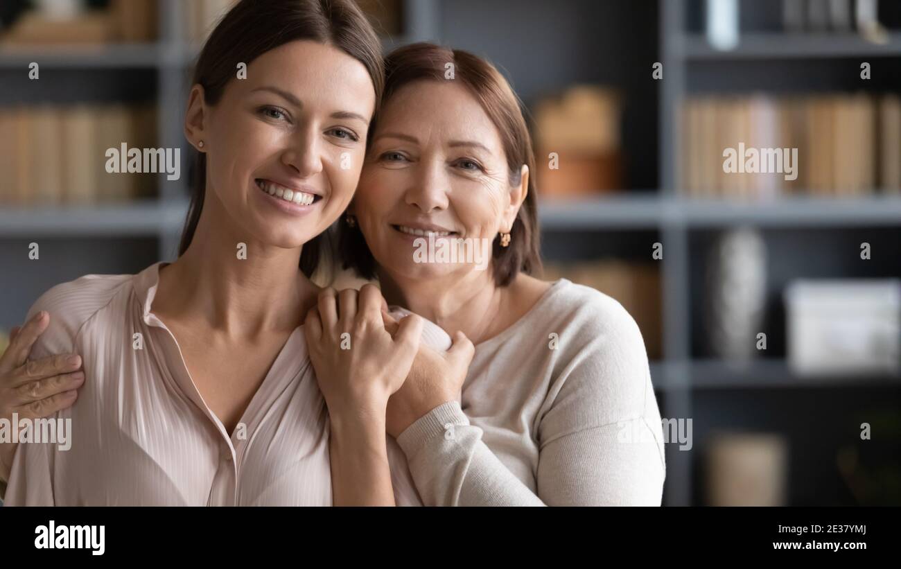 Head shot portrait happy two generations of women hugging Stock Photo ...