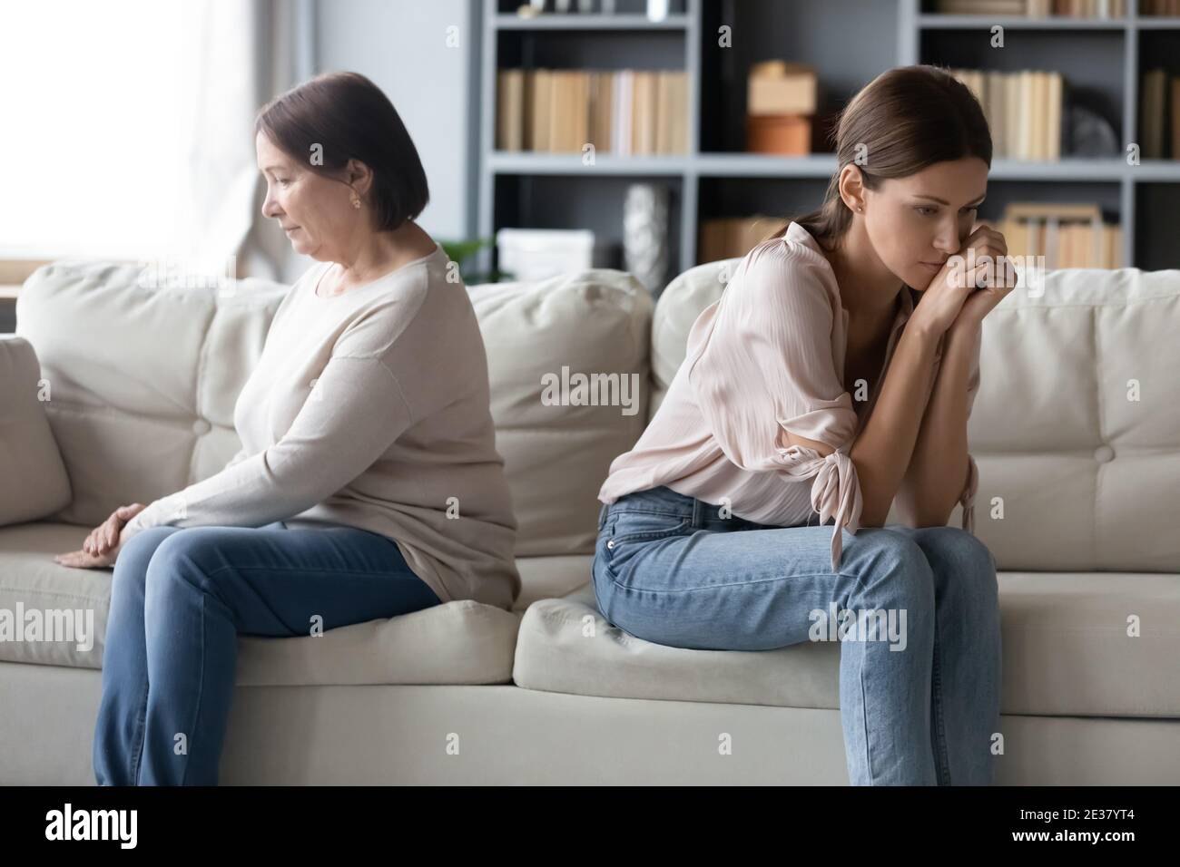 Unhappy mature mother and grownup daughter ignoring each other Stock Photo - Alamy