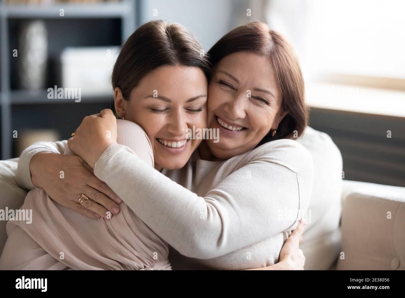 Close up smiling grownup daughter and mature mother cuddling Stock Photo - Alamy
